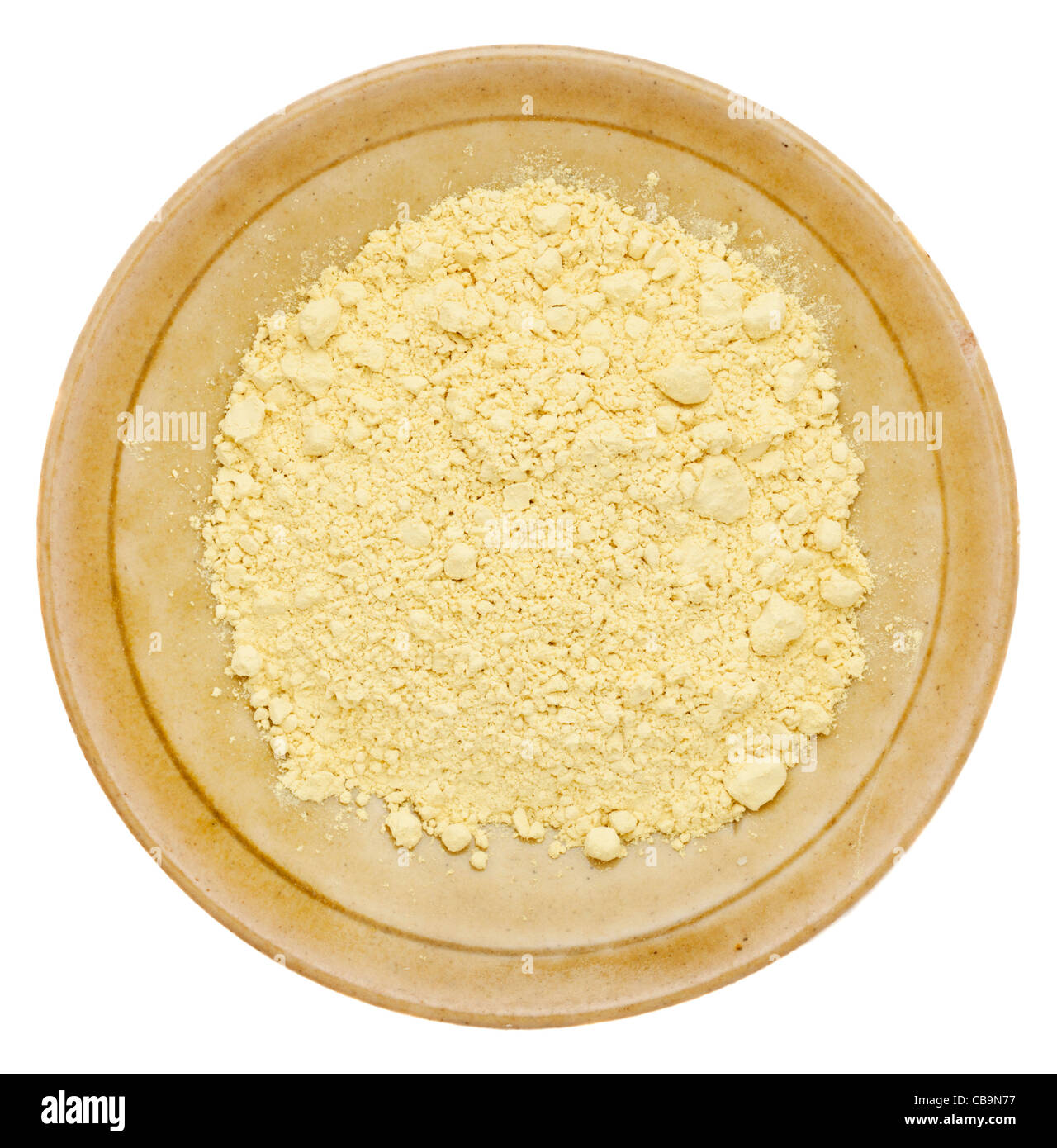pine pollen powder (nutrition supplement) on a isolated small ceramic ...