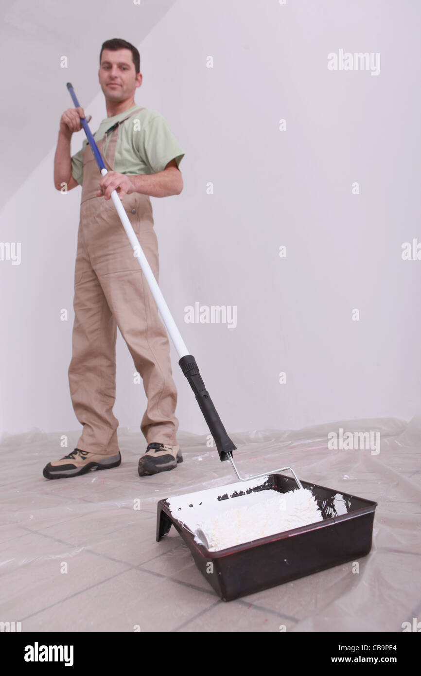 worker painting with a roller Stock Photo - Alamy