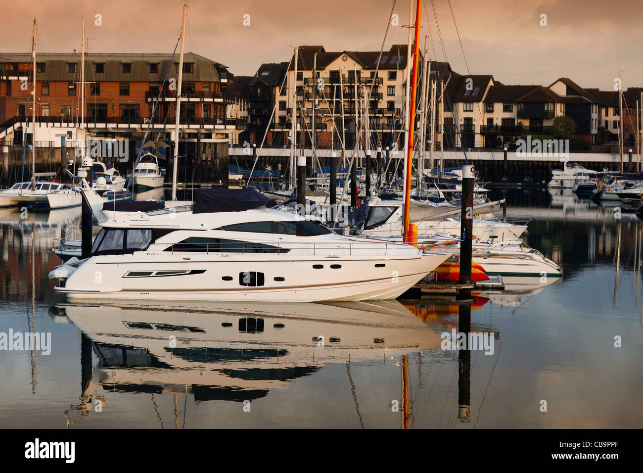 Powerboat and reflection in Southampton Ocean Village Marina at dusk ...