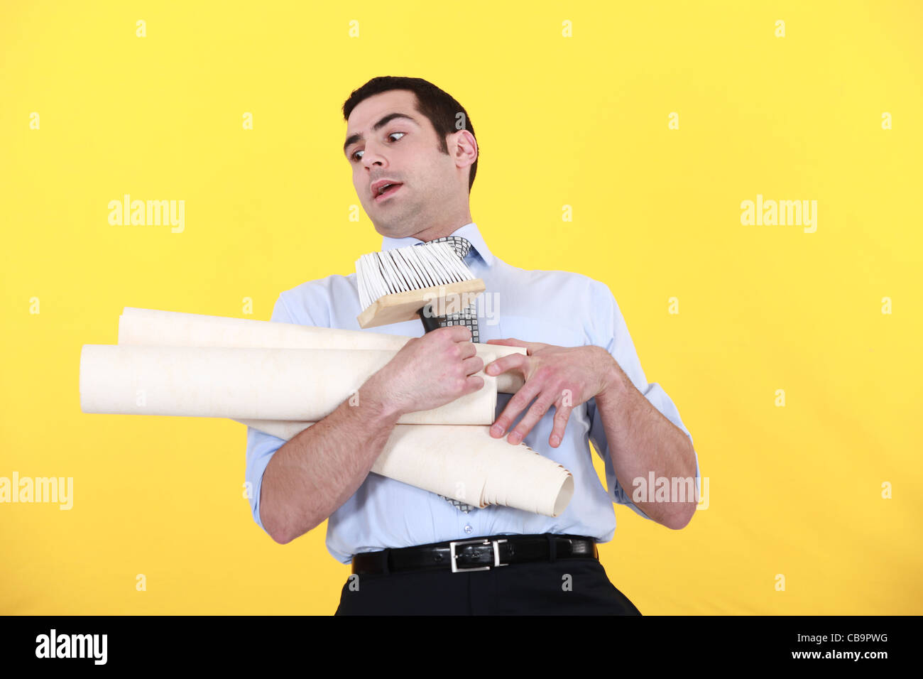 Man struggling to carry wallpaper Stock Photo - Alamy