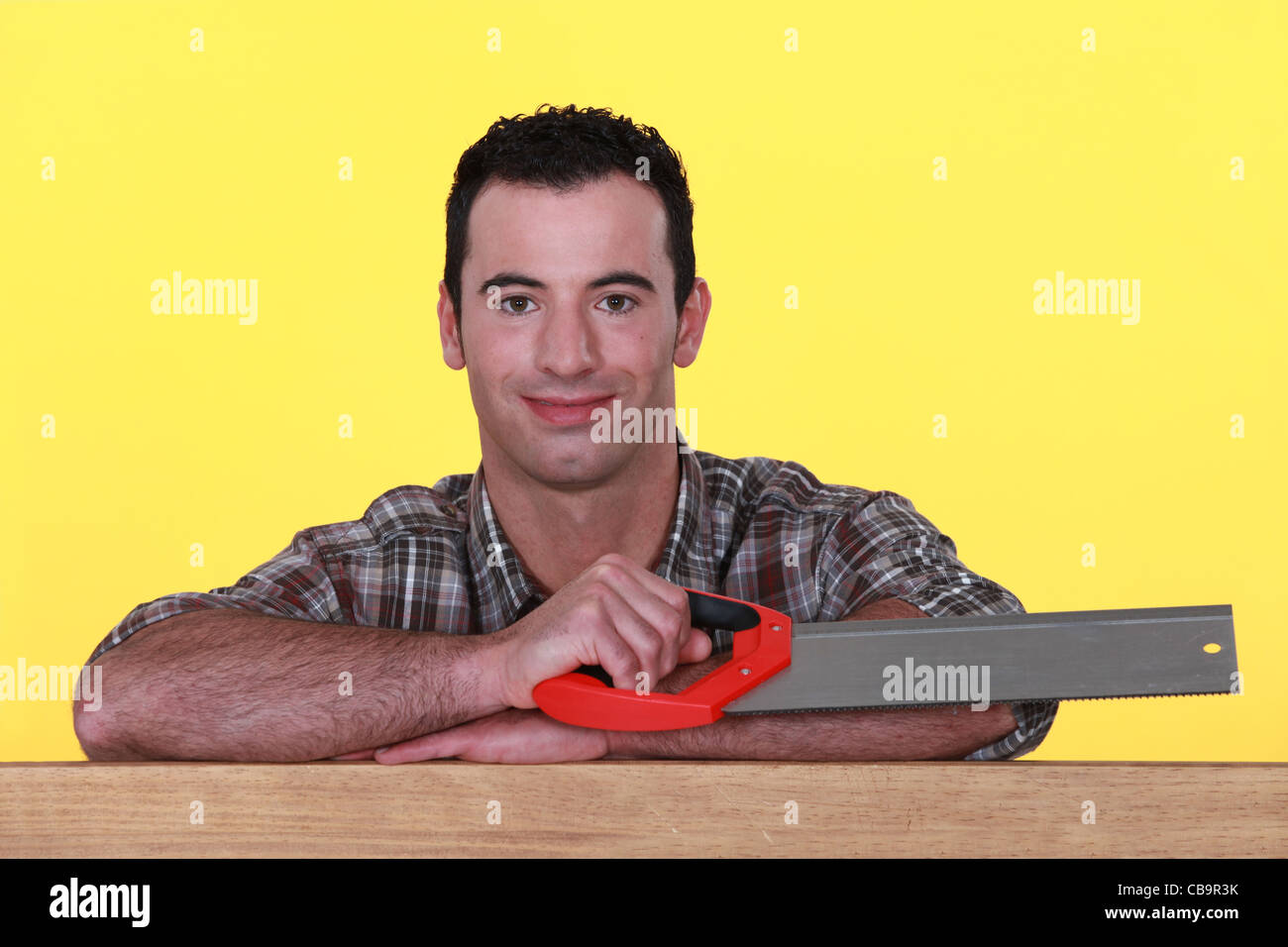 Man using hand-saw Stock Photo - Alamy