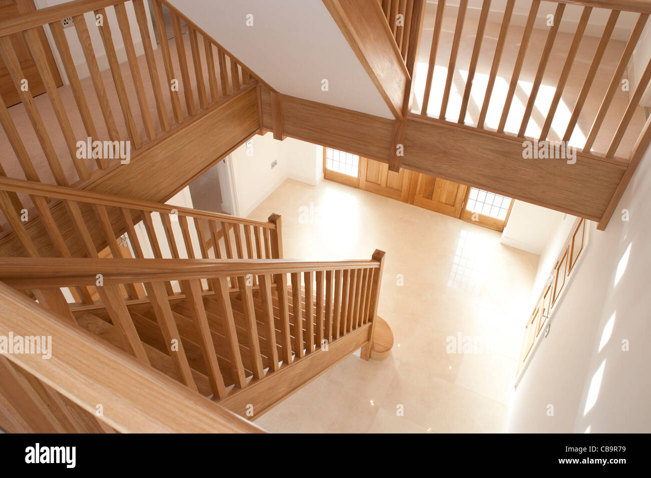 Abstract shot of wooden staircase from first floor looking into marble ...