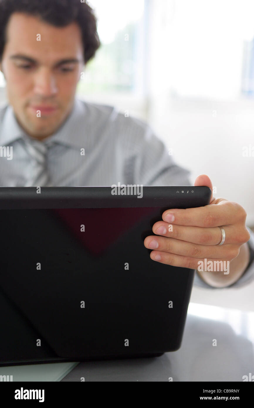 Man adjusting his laptop screen Stock Photo - Alamy