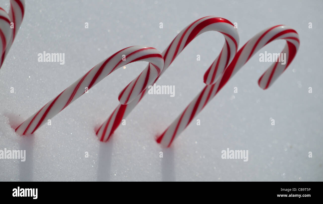 Traditional holiday candy candy cane in snow Stock Photo - Alamy