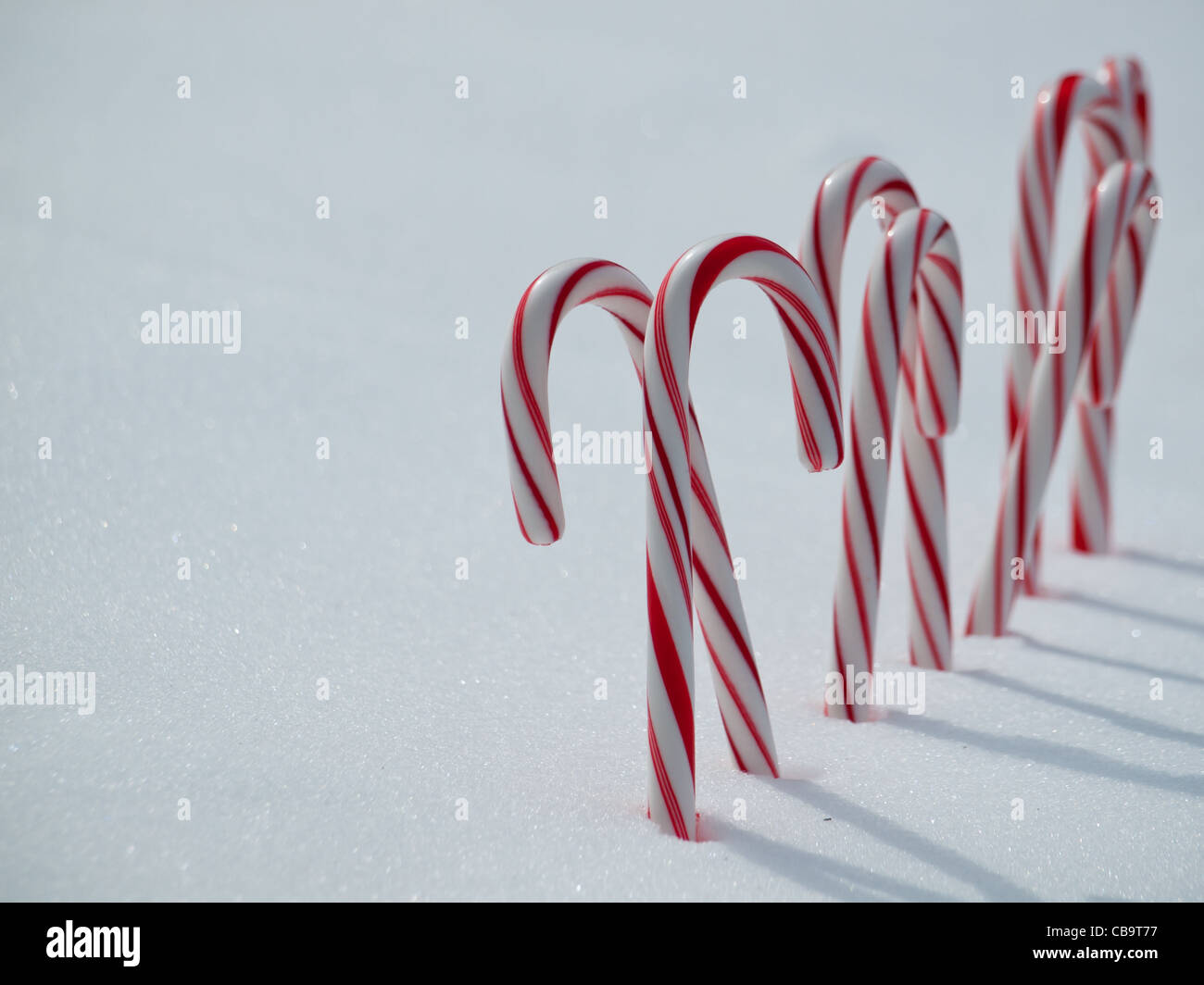 Traditional holiday candy candy cane in snow Stock Photo - Alamy