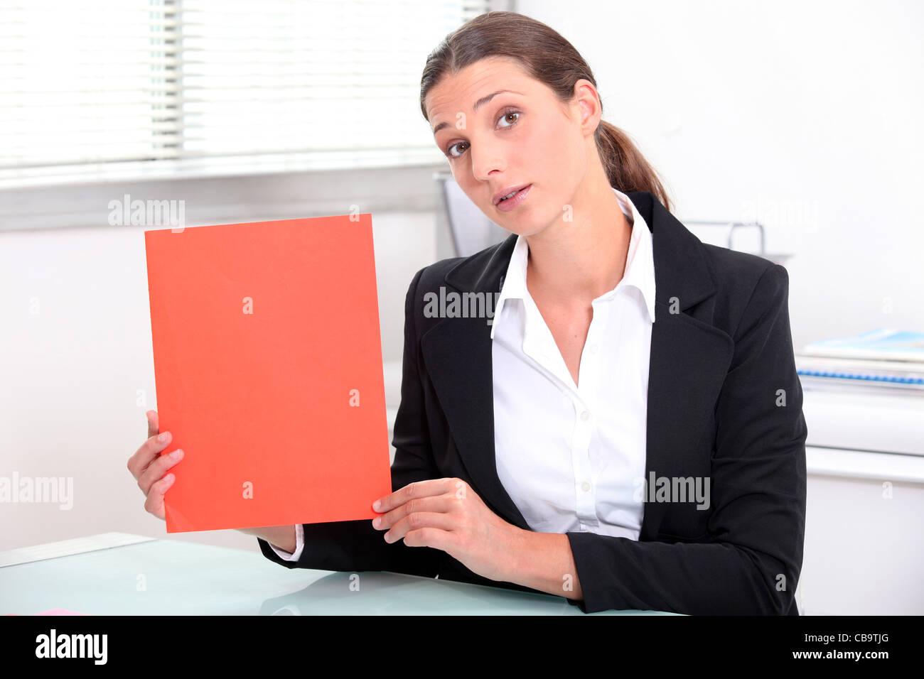 Young woman holding up a red file Stock Photo - Alamy