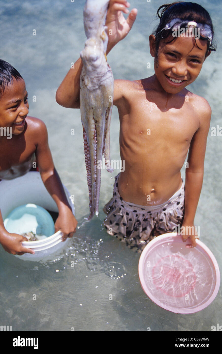 Western Samoa, Manono Island, village children, boy & girl fresh caught ...