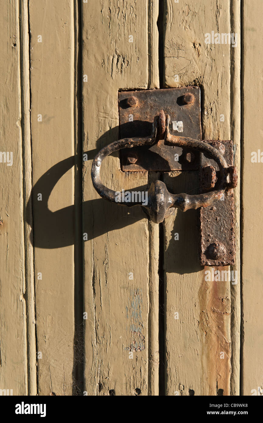Rusty old fashioned door mechanism in weathered door Stock Photo - Alamy