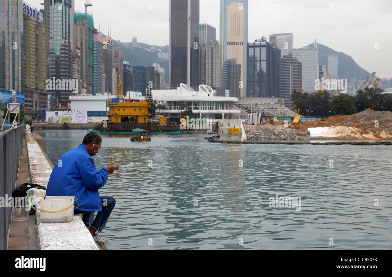 chinese man fishing with line on hong kong waterfront hksar china Stock ...