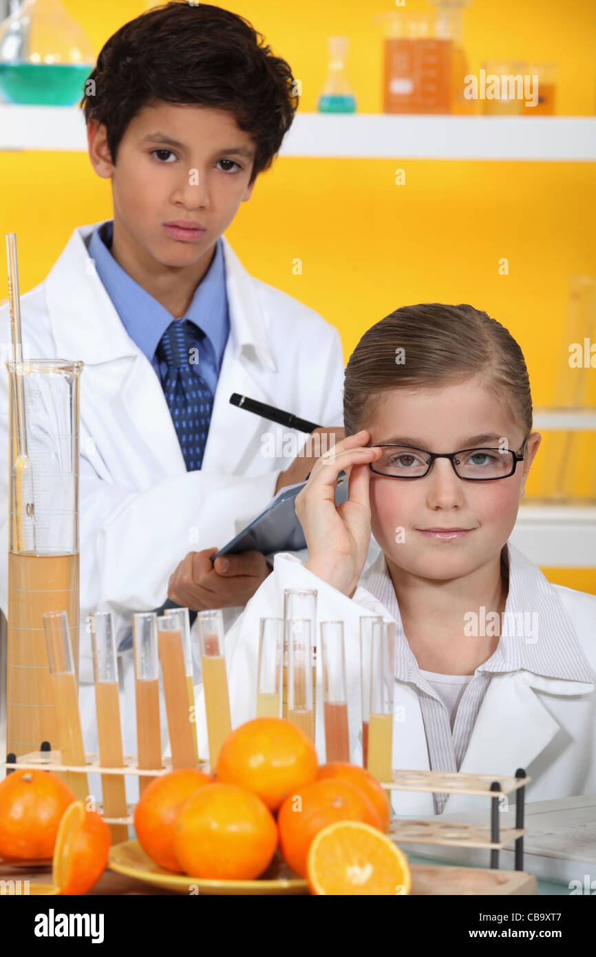 Children analysing orange juice Stock Photo - Alamy
