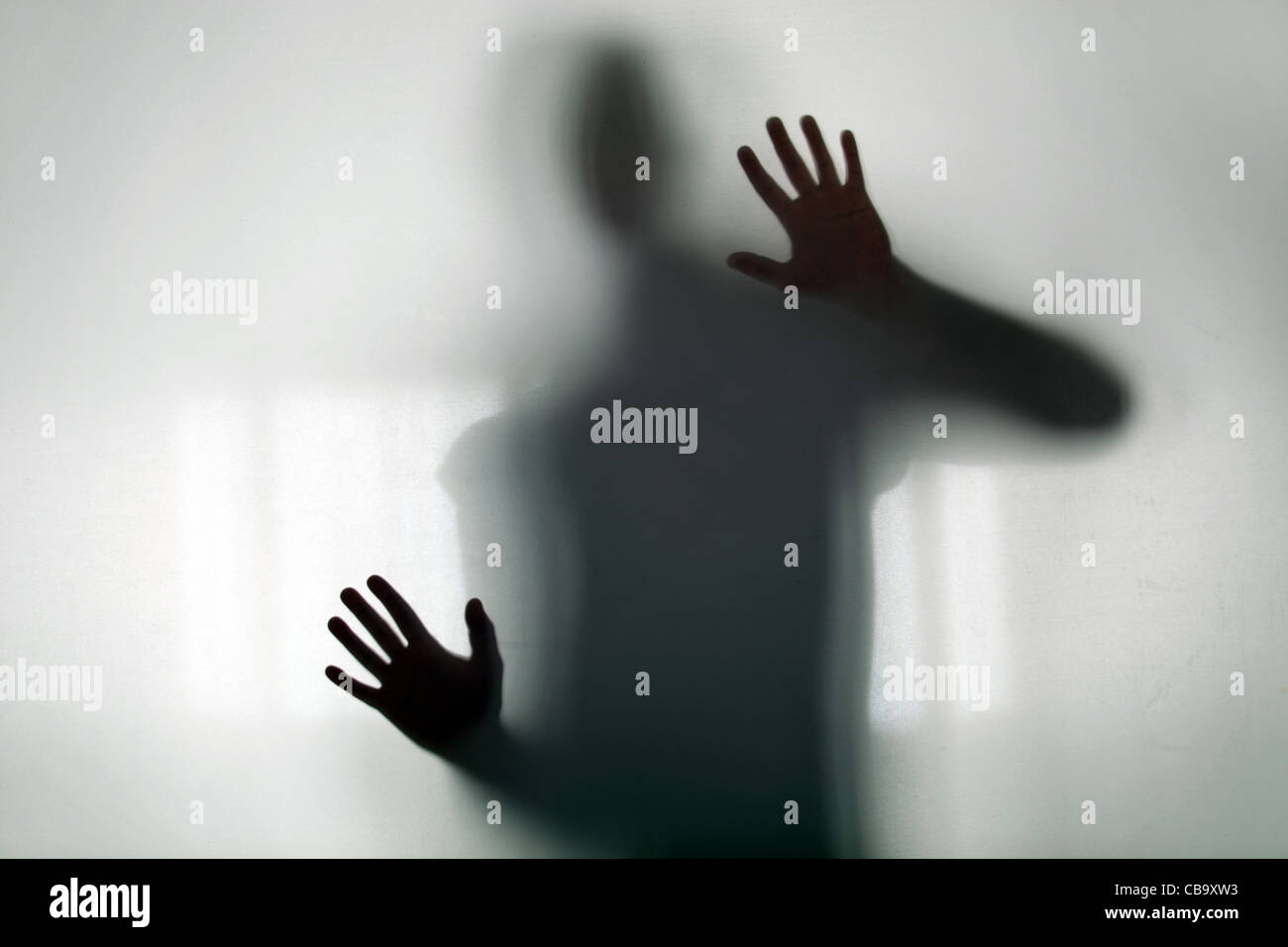 Shadow figure behind glass hi-res stock photography and images - Alamy