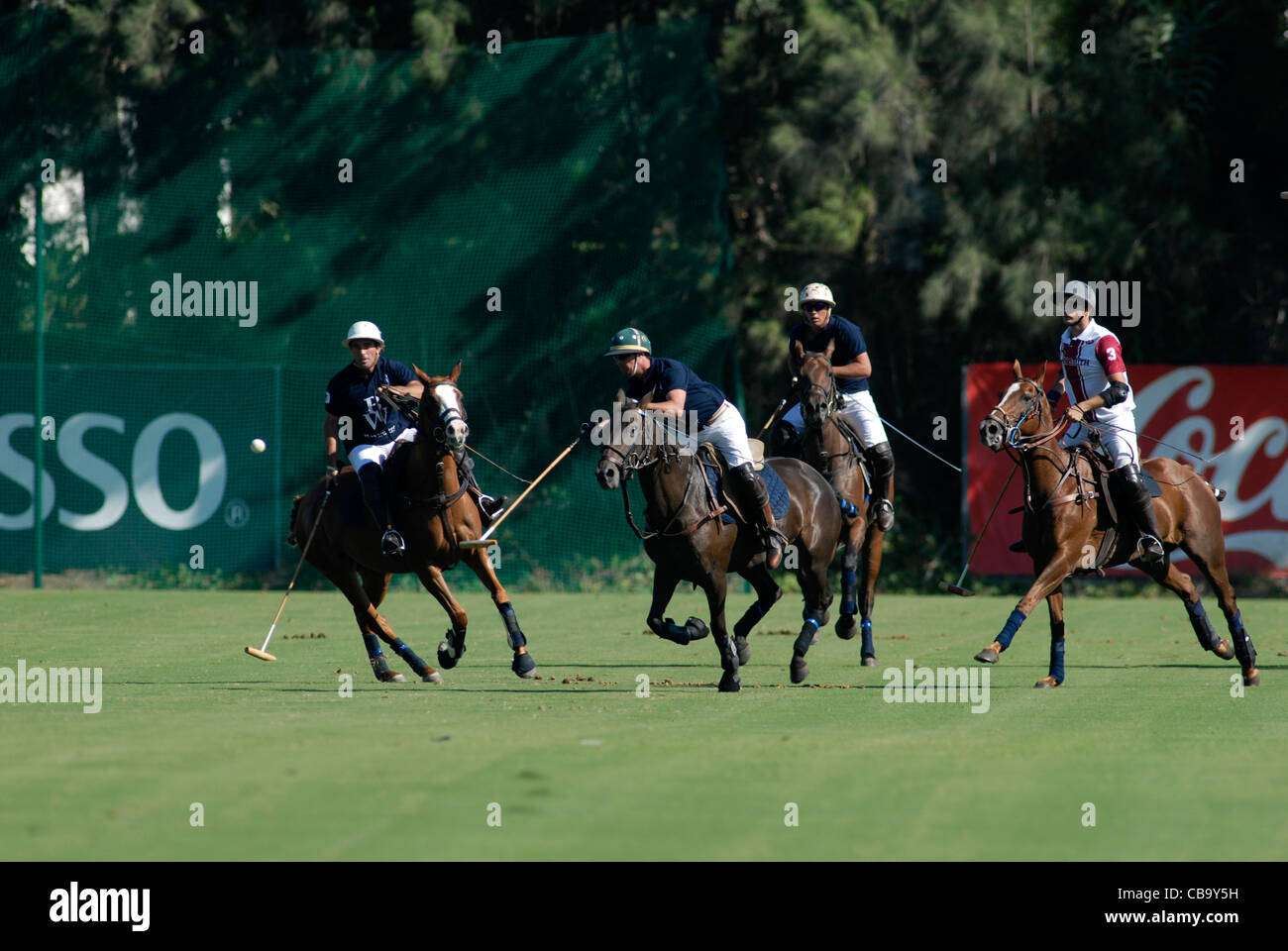 Polo players chasing ball in the air during match Stock Photo - Alamy