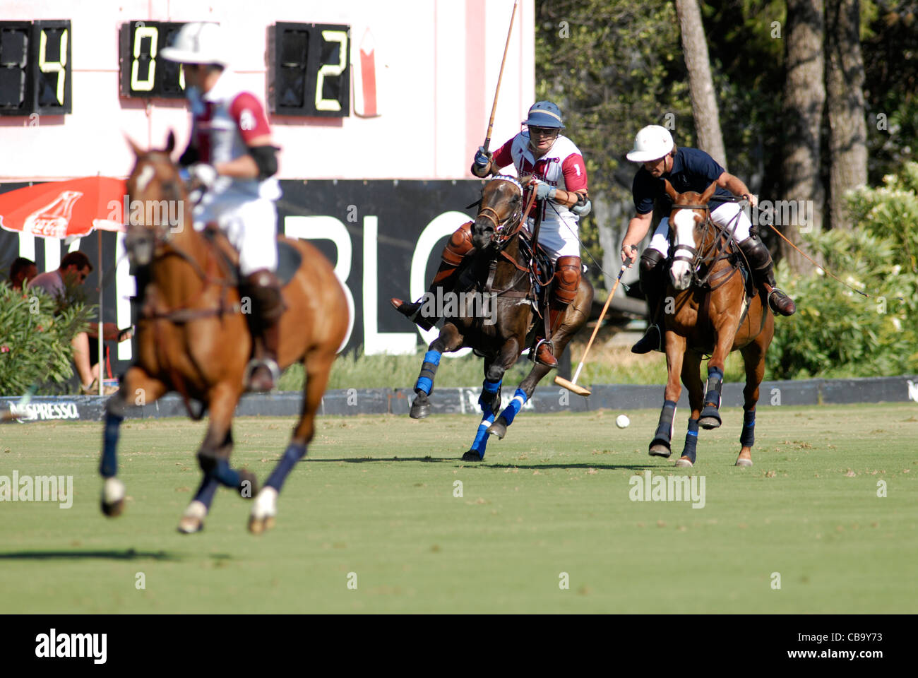 2 polo players chasing ball during match Stock Photo - Alamy
