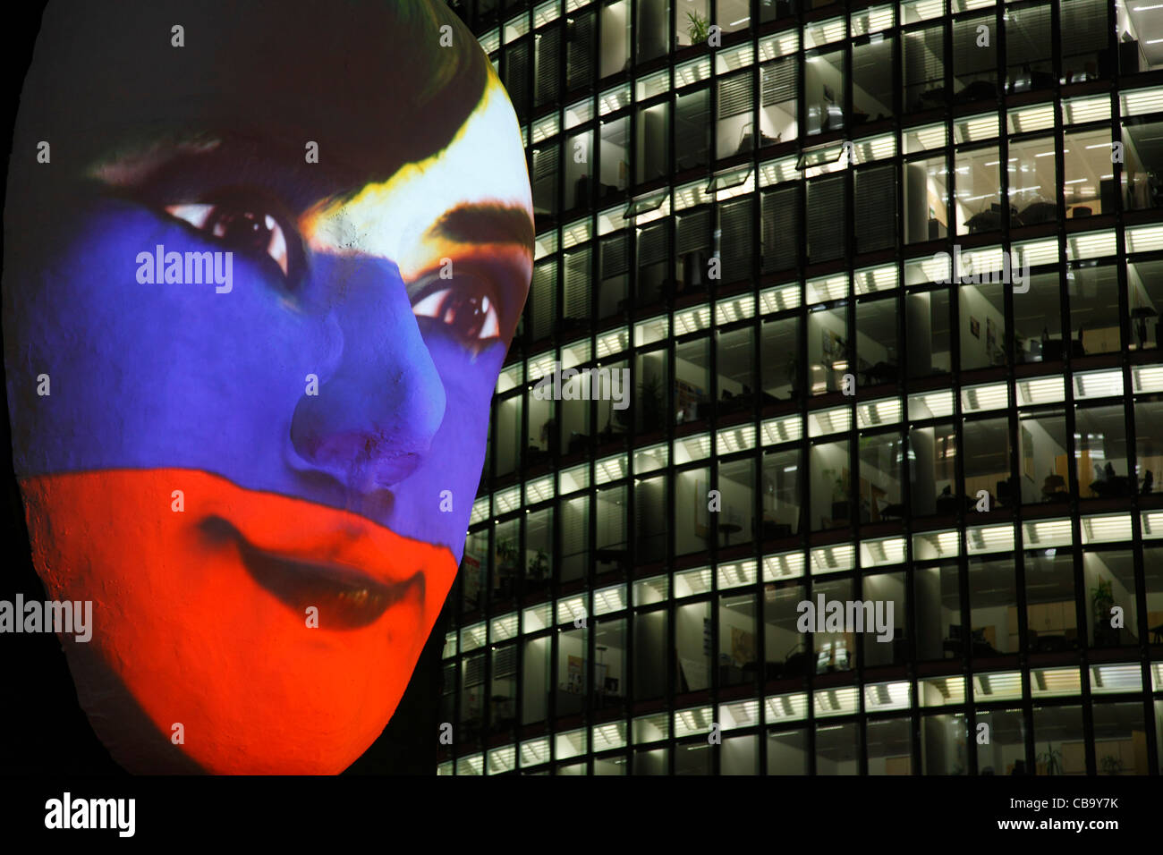Huge sculpture of a face illuminated by an image of a Czech flag ...
