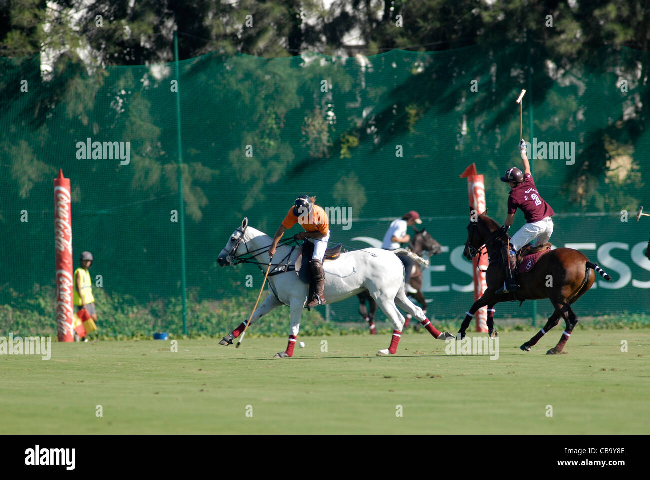 2 polo players in action in front of goal Stock Photo - Alamy
