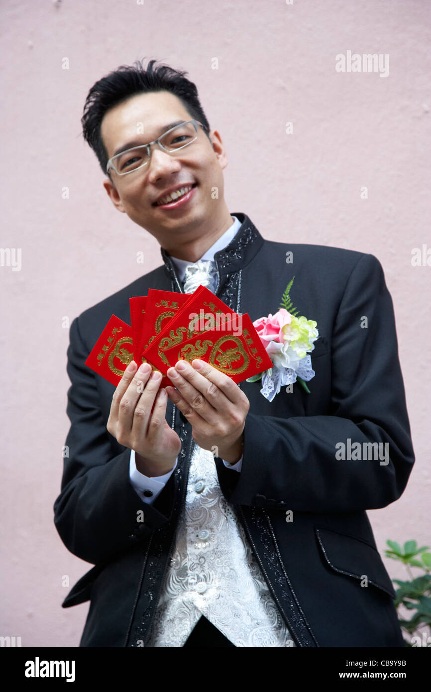 chinese bridegroom with lucky red and gold money envelopes on his ...
