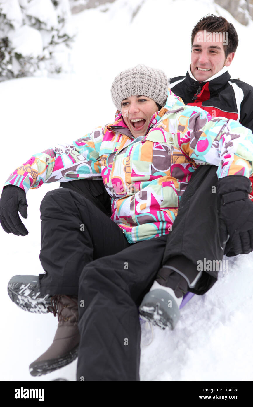 Couple on a sledge Stock Photo - Alamy