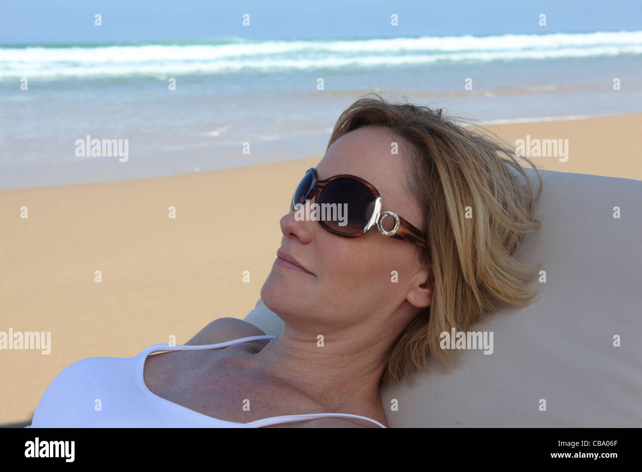 portrait of a woman resting on the beach Stock Photo - Alamy
