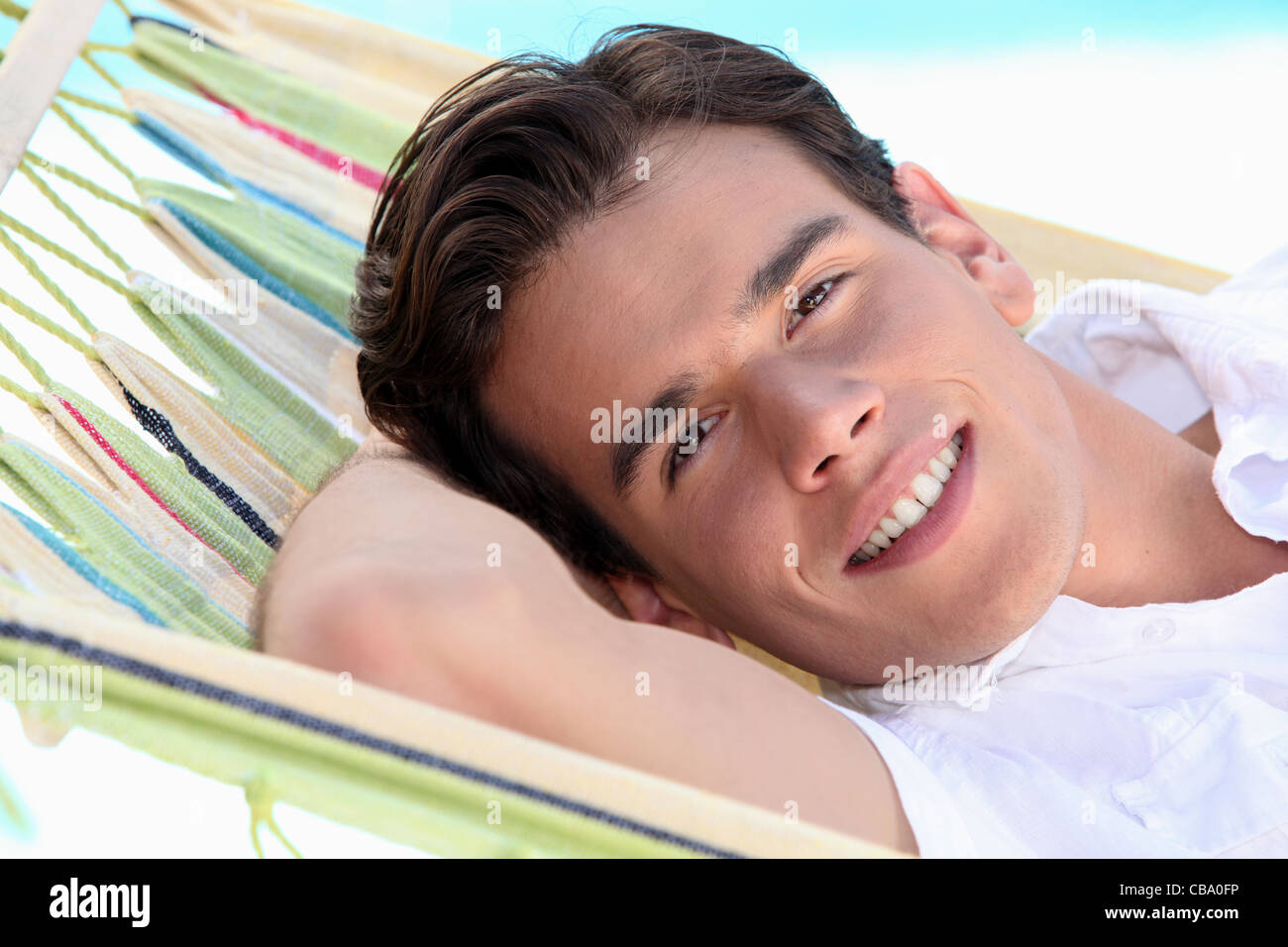 Man laying in hammock Stock Photo - Alamy