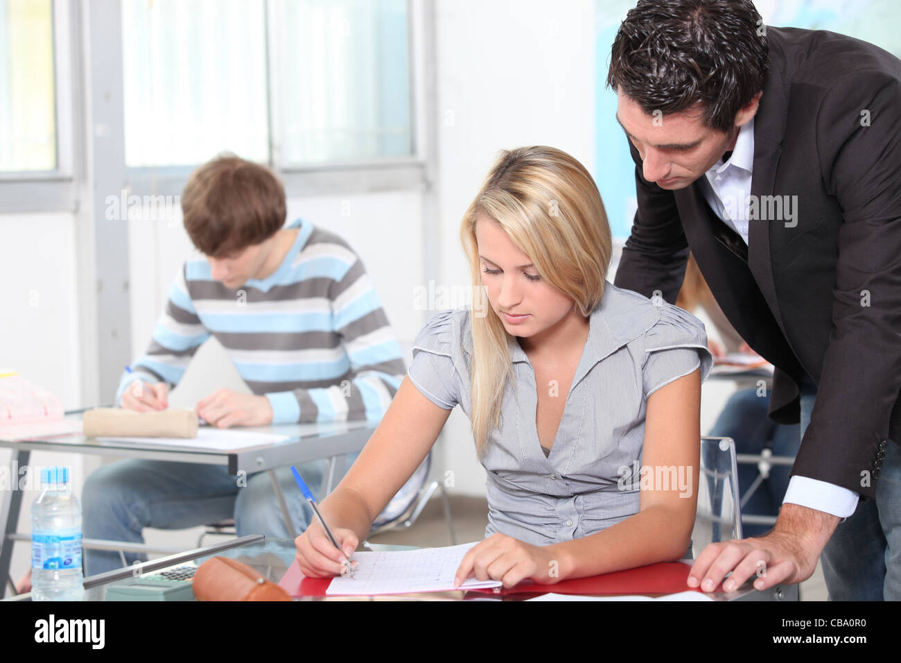 Teacher watching students test hi-res stock photography and images - Alamy