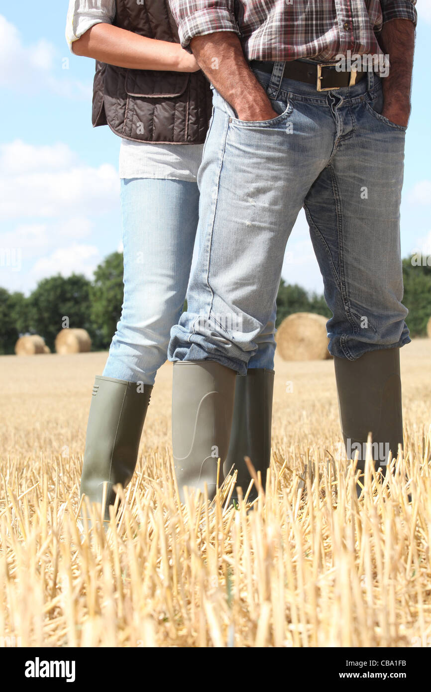 Farming couple in field Stock Photo - Alamy