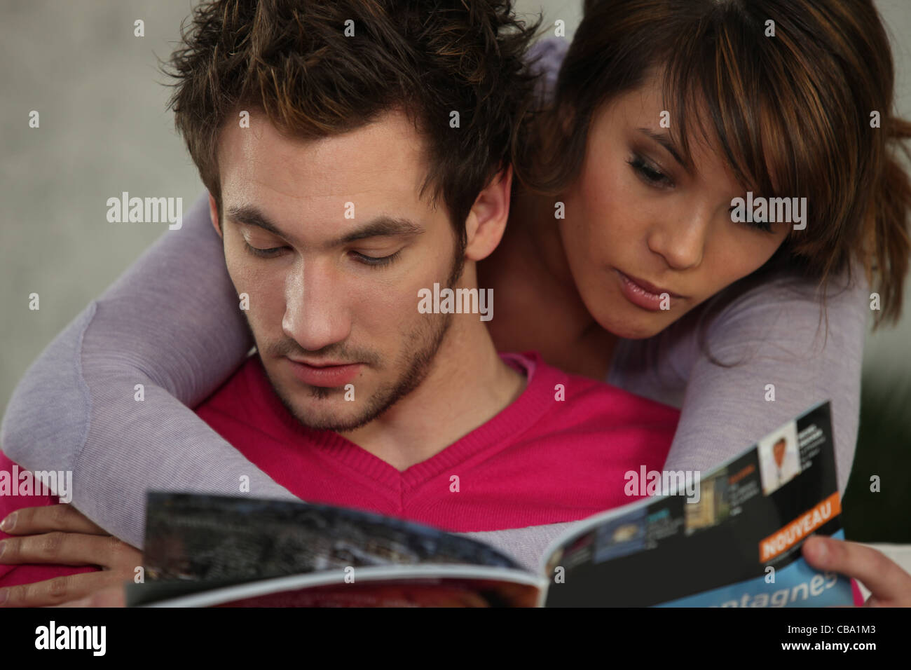 Couple reading magazine Stock Photo - Alamy