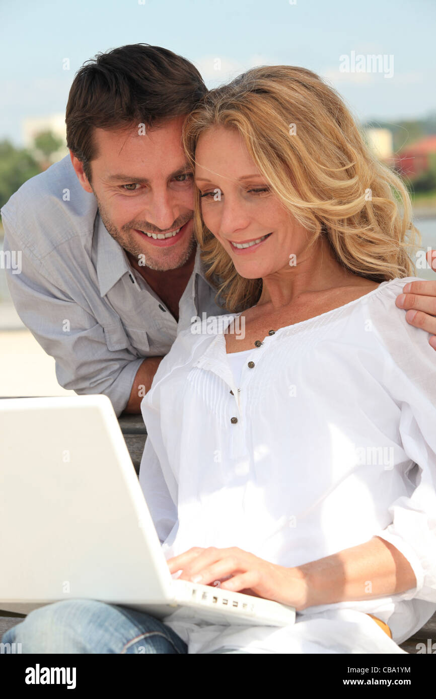 portrait of a couple with laptop Stock Photo - Alamy