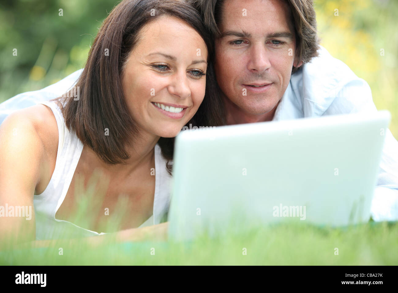 Couple on laptop Stock Photo - Alamy