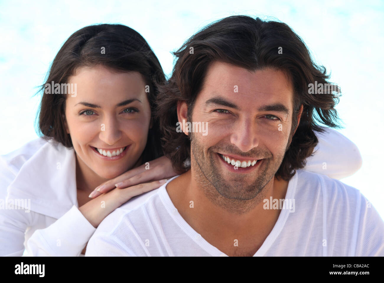 Head and shoulders shot of a well matched couple in white Stock Photo ...