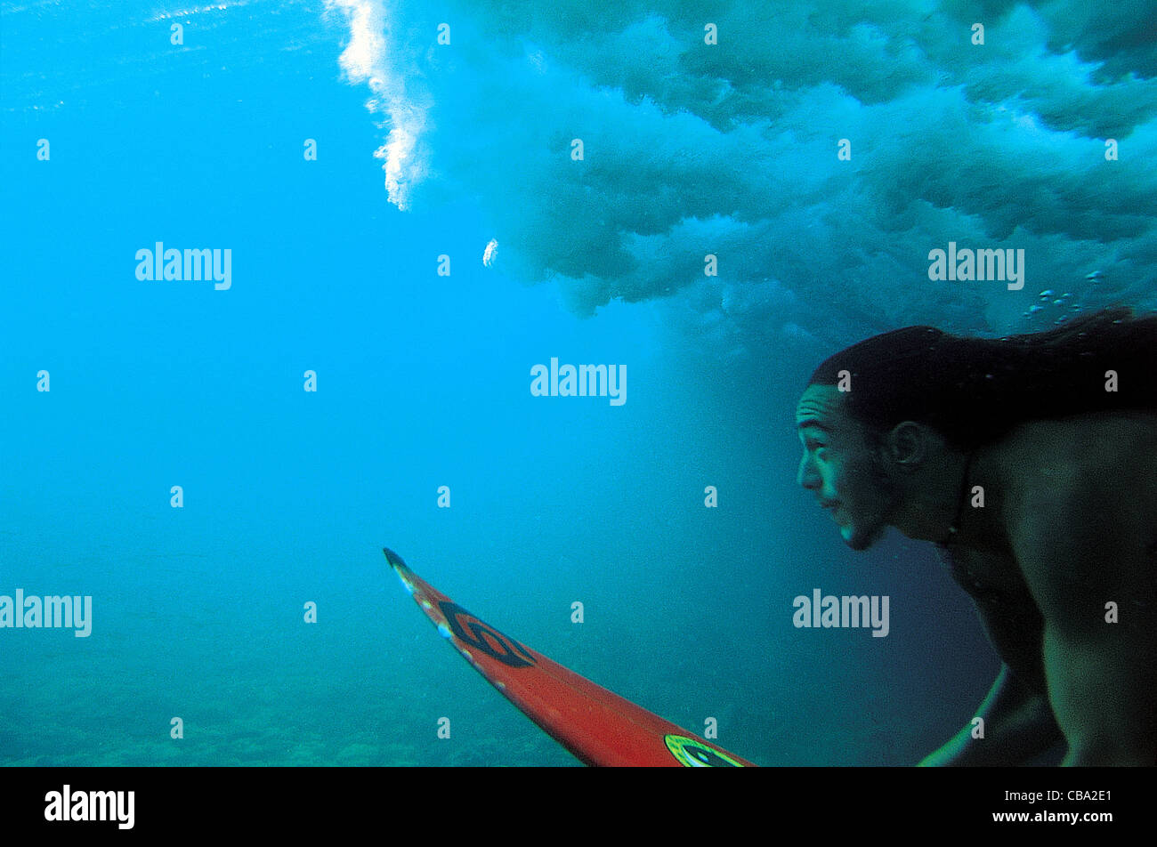 Surfer diving under a wave at Motu Hava. Hanga Roa, Rapa Nui (Easter ...