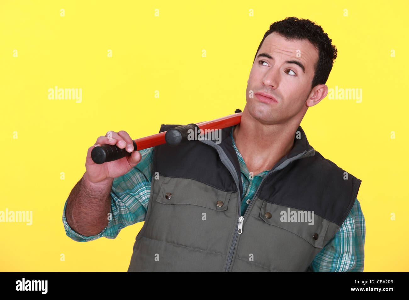Man resting bolt cutters over shoulder Stock Photo - Alamy