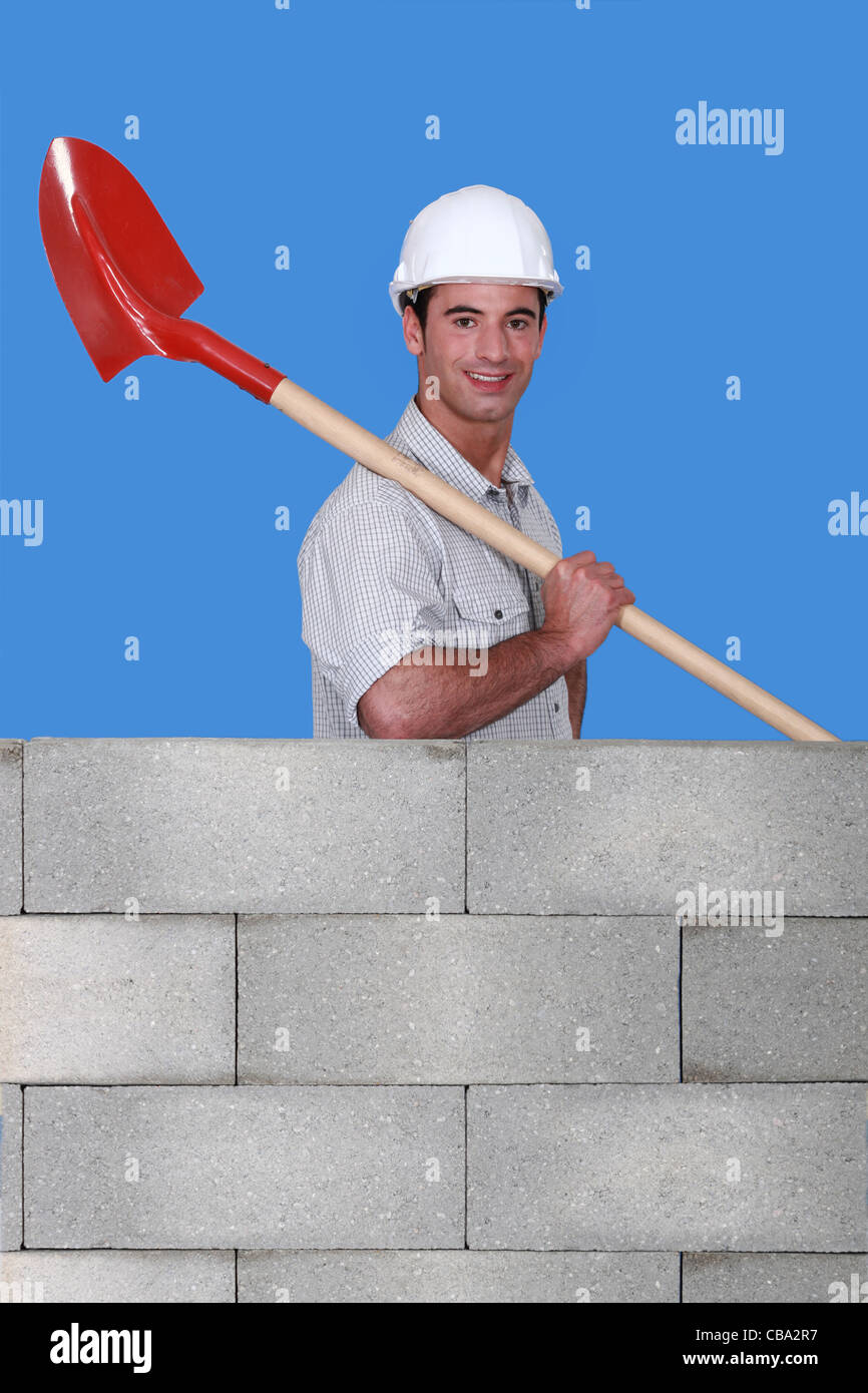 Builder with a shovel Stock Photo - Alamy