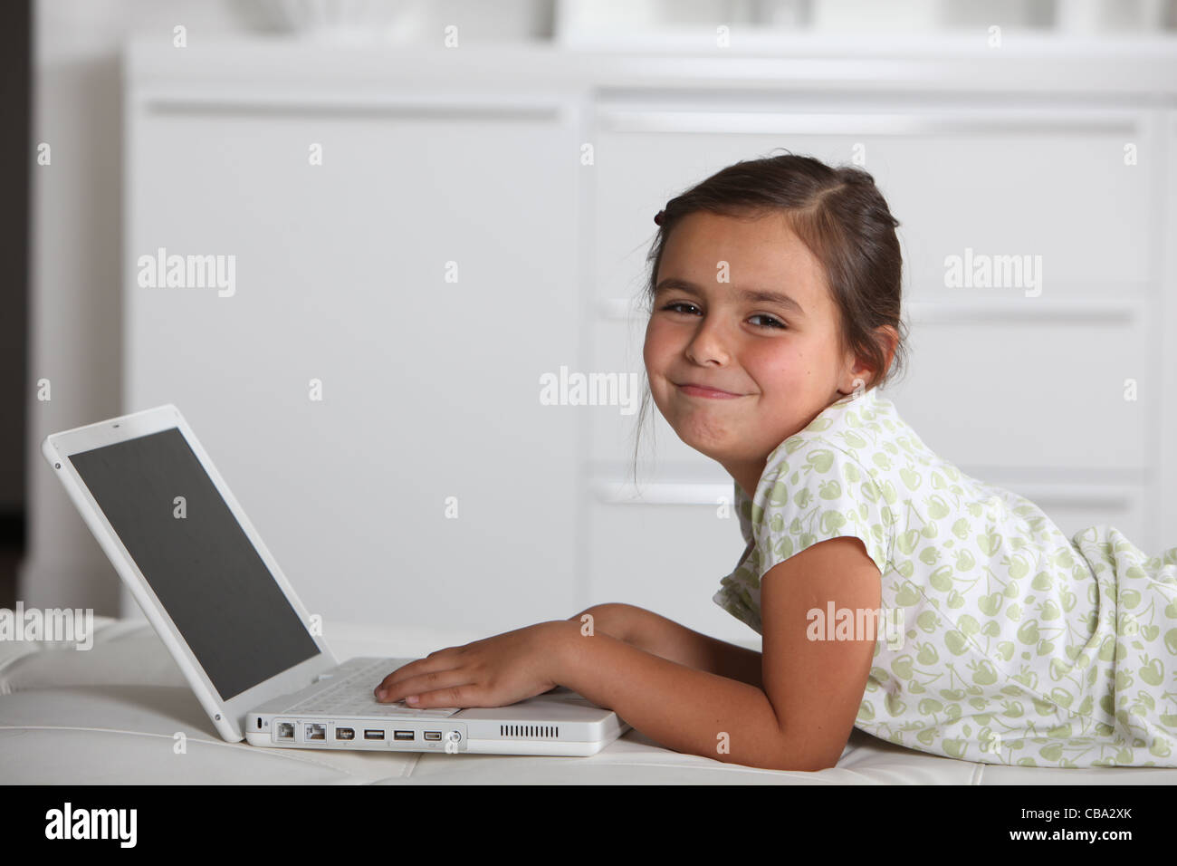 Young girl using a laptop computer Stock Photo - Alamy