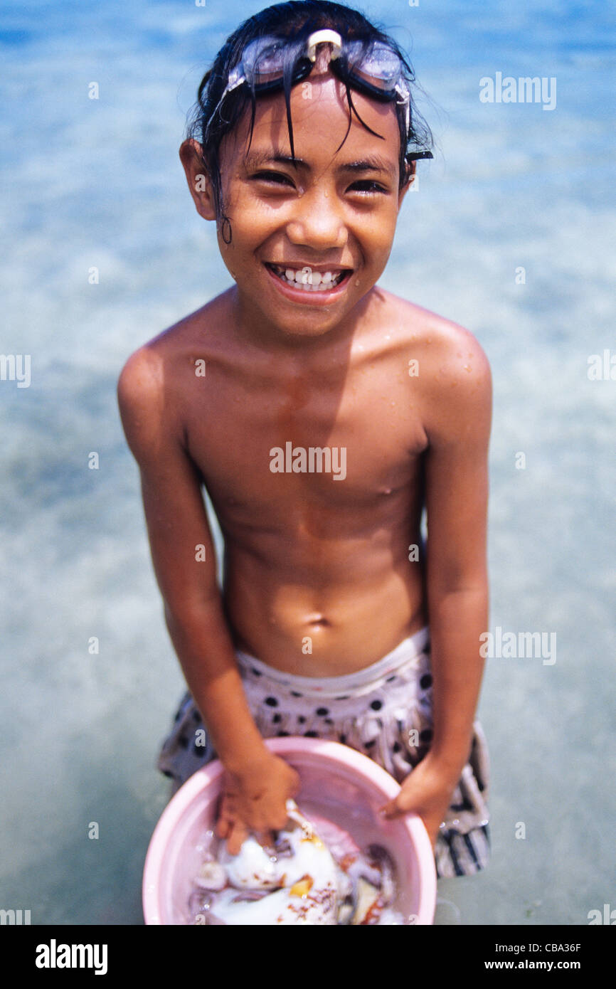 Western Samoa, Manono Island, village children, girl with fresh caught ...