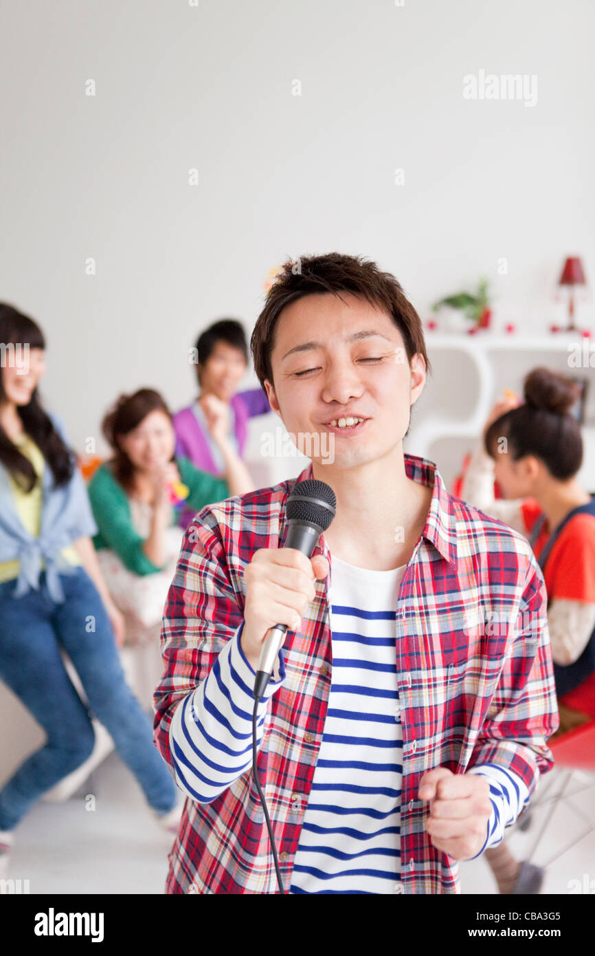 Young people singing karaoke Stock Photo - Alamy