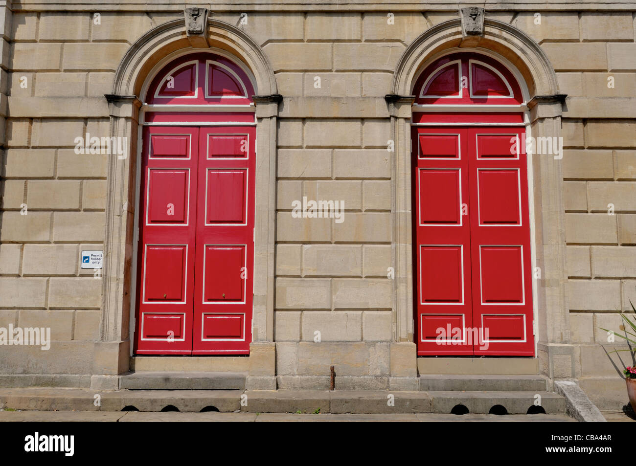 Red door - building detail with contrasting color Stock Photo - Alamy