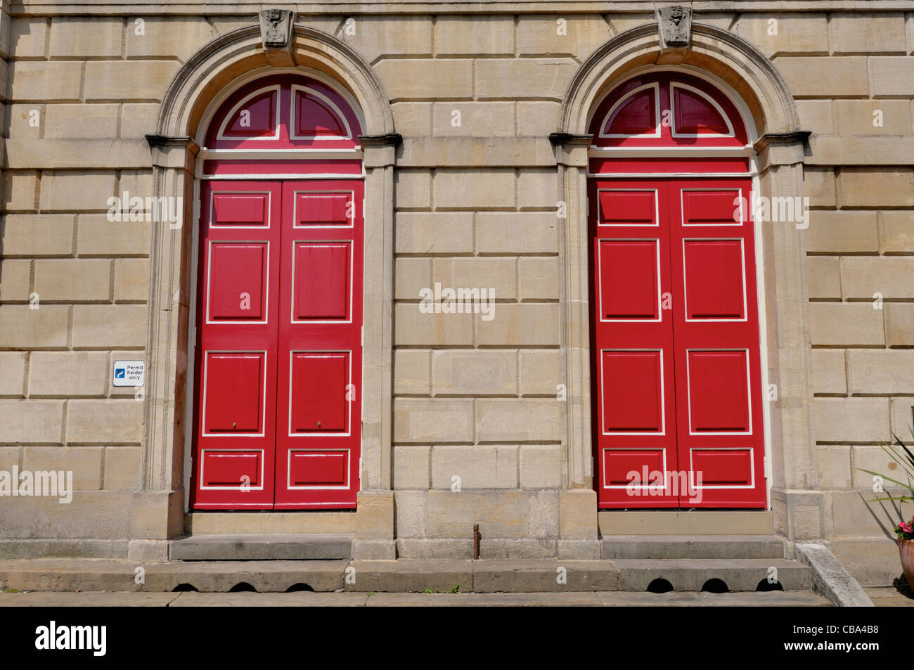 Red door - building detail with contrasting color Stock Photo - Alamy