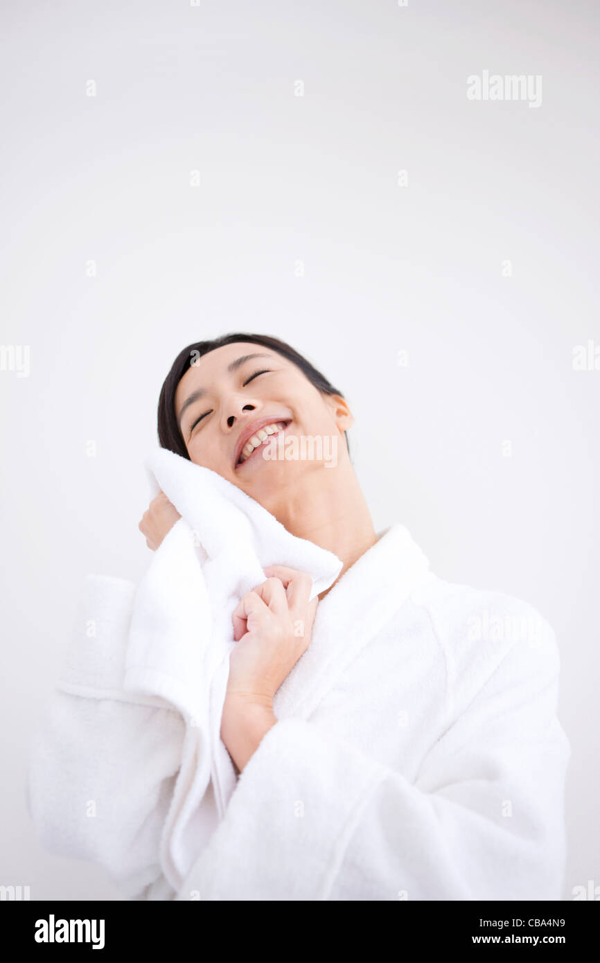 Woman wiping face with towel Stock Photo - Alamy