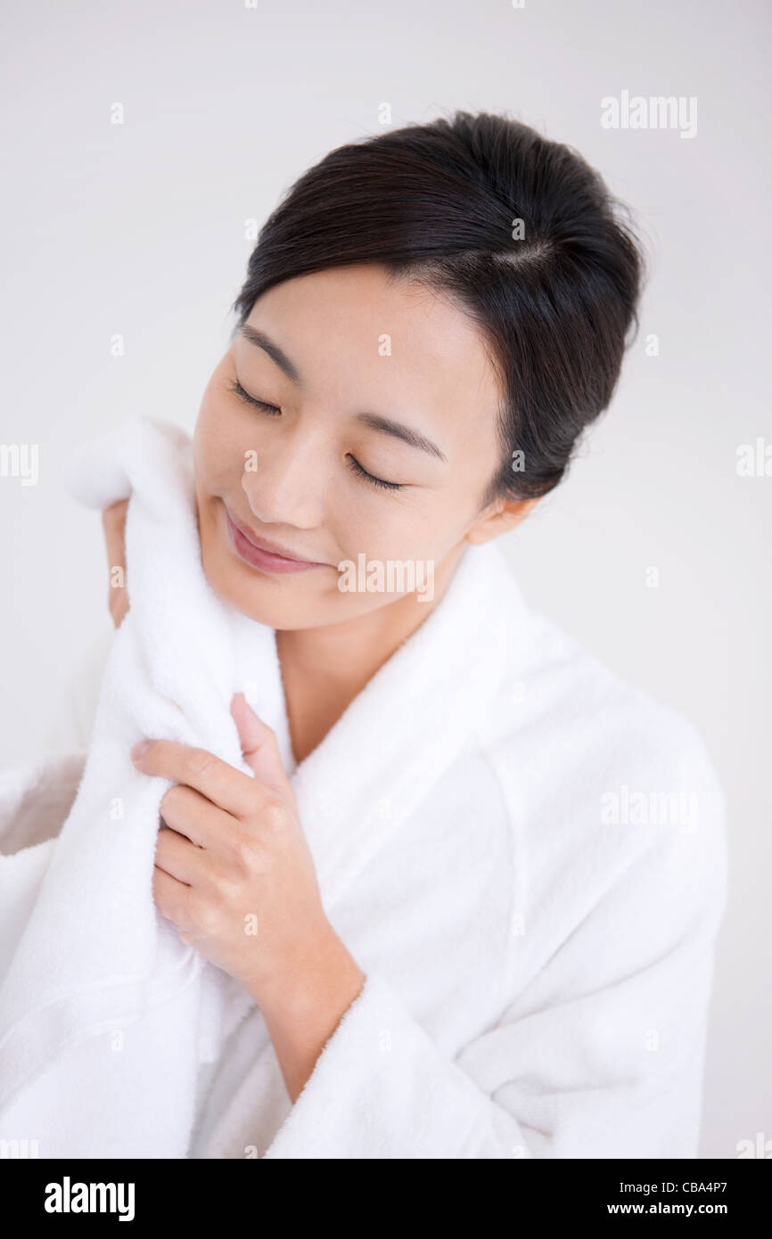 Woman wiping face with towel Stock Photo - Alamy