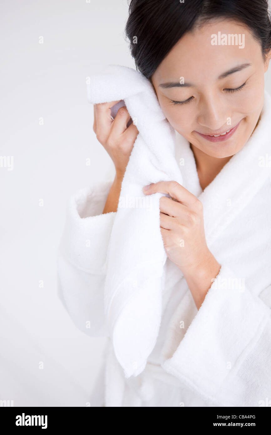 Woman wiping face with towel Stock Photo - Alamy