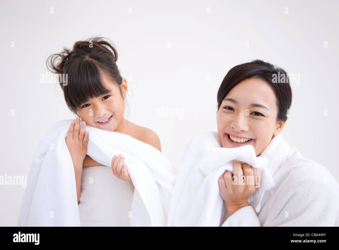 Mother and daughter wiping face with towel Stock Photo - Alamy