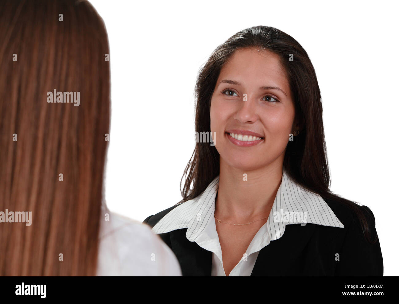Two young women discussing isolated against a white background Stock ...