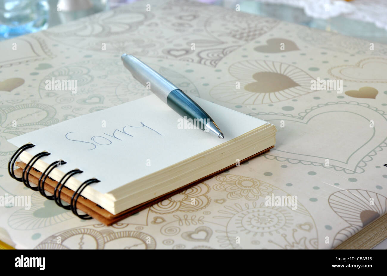 Say sorry with a text message on paper and pen Stock Photo - Alamy