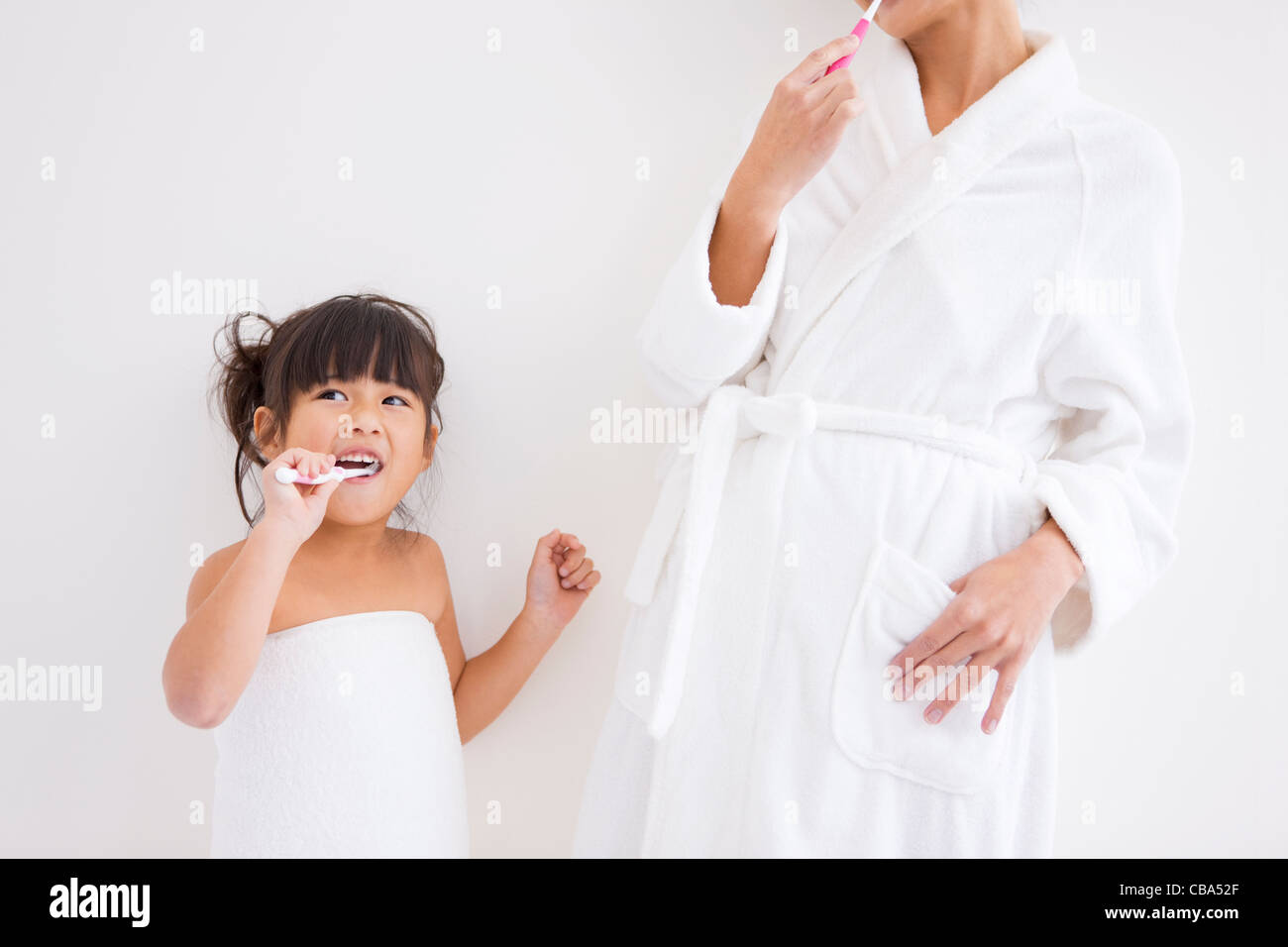 Mother and daughter brushing teeth Stock Photo - Alamy