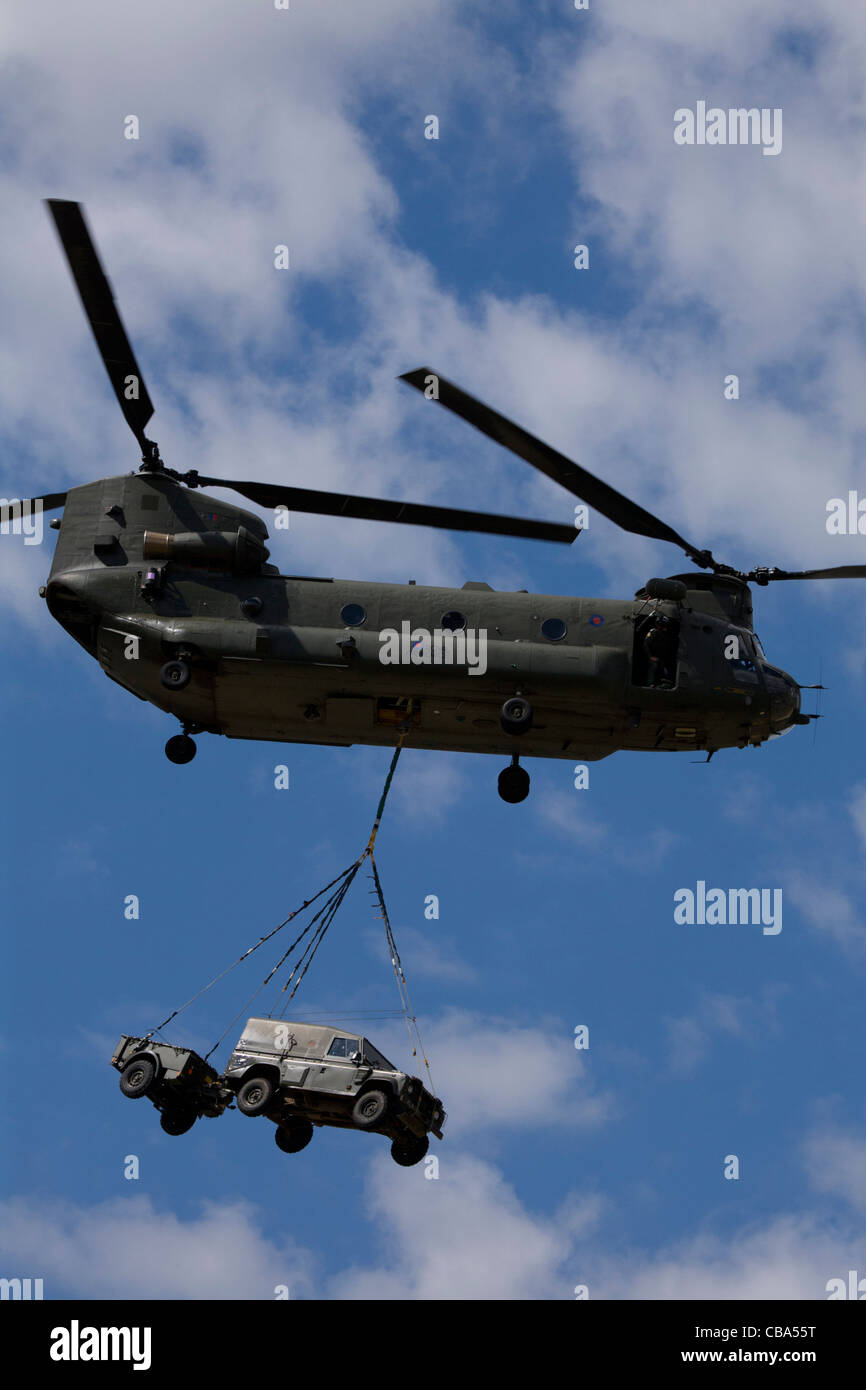Boeing Chinook helicopter carrying army truck and trailor at ...