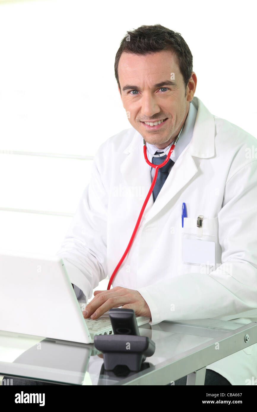 Doctor working on his laptop Stock Photo - Alamy