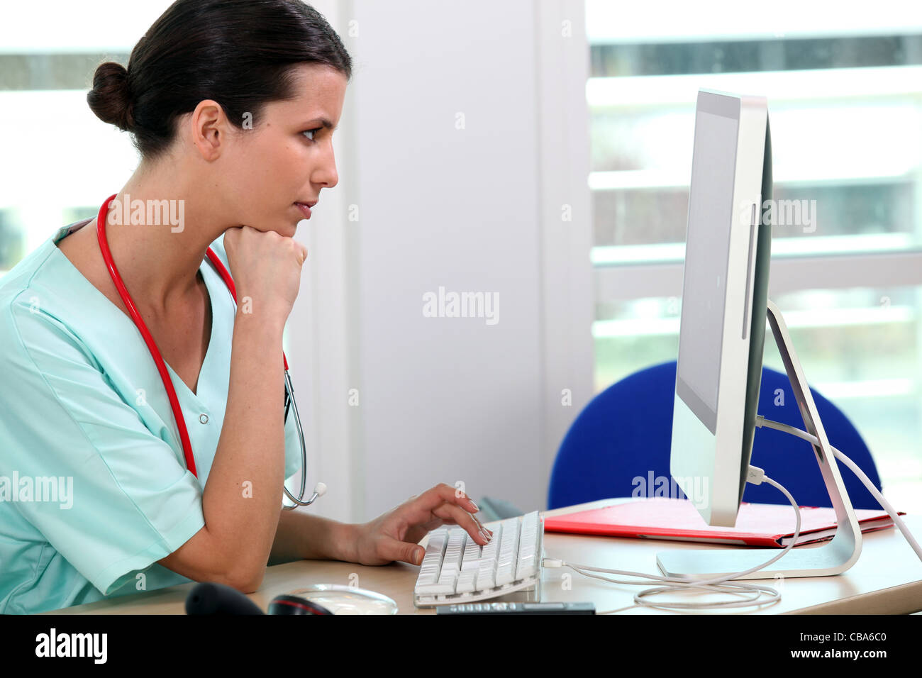 Nurse working on the computer Stock Photo - Alamy