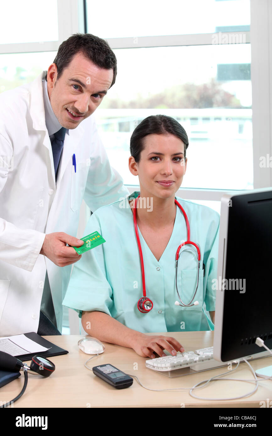 Doctor posing with his assistant Stock Photo - Alamy