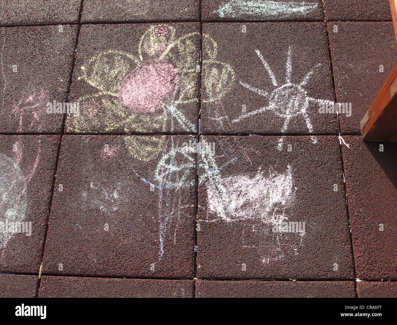 chalk drawing of flower and sun on playground floor Stock Photo - Alamy