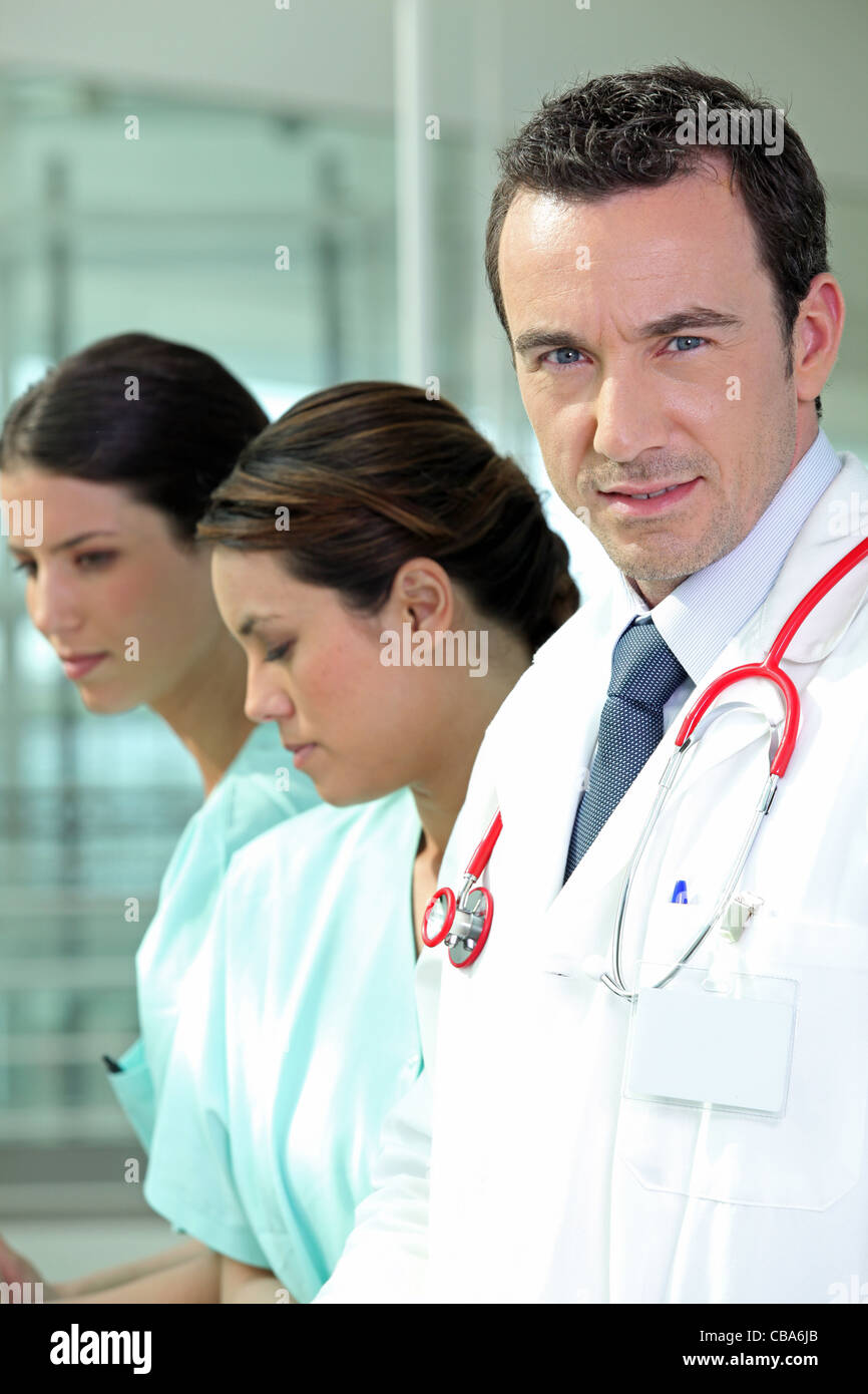 Practitioner and female nurses Stock Photo - Alamy